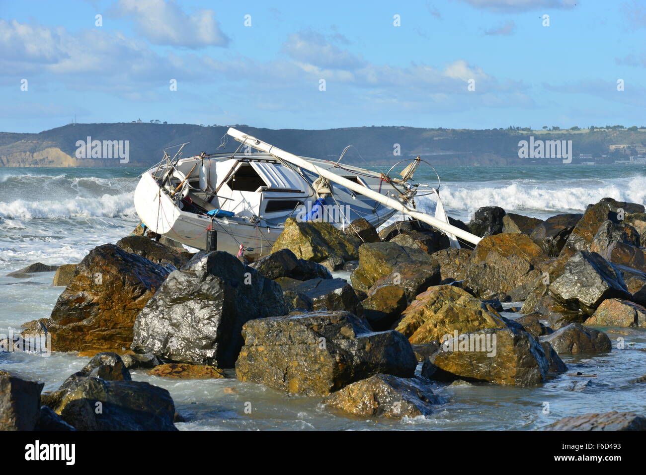 A Yacht being ship wrecked on the rocks on the beach at San Diego ...