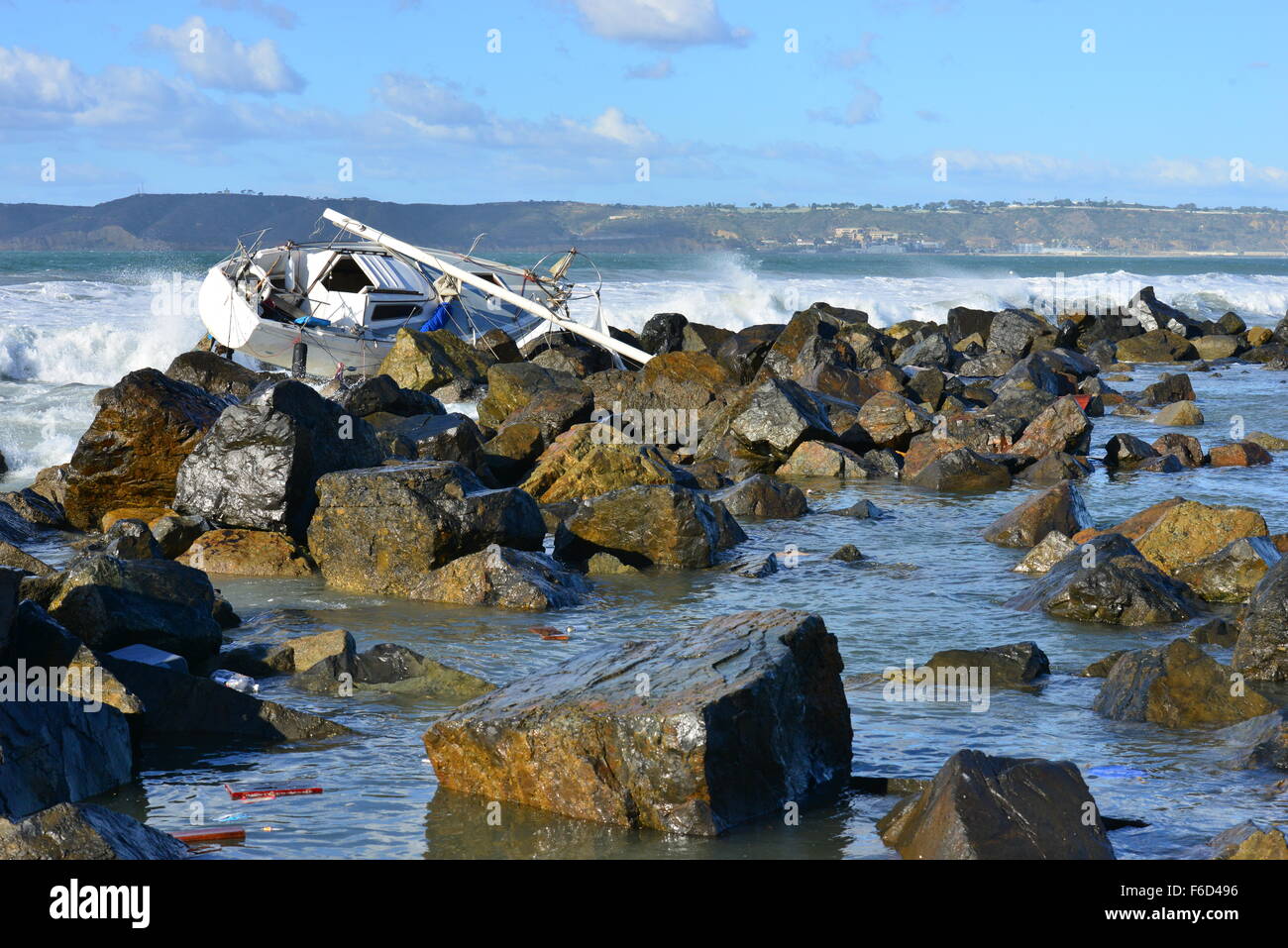A Yacht being ship wrecked on the rocks on the beach at San Diego ...