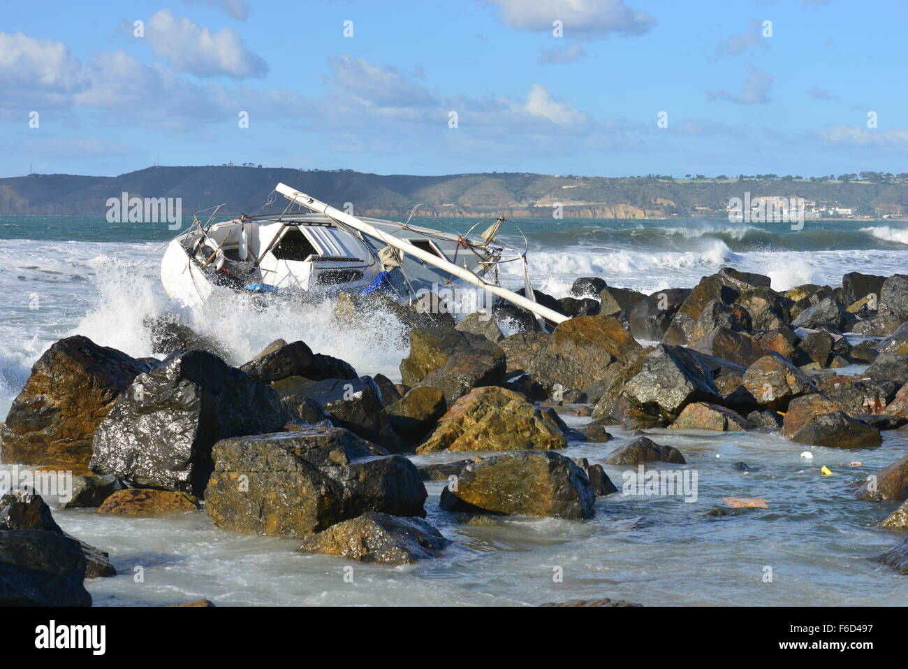 A Yacht being ship wrecked on the rocks on the beach at San Diego ...