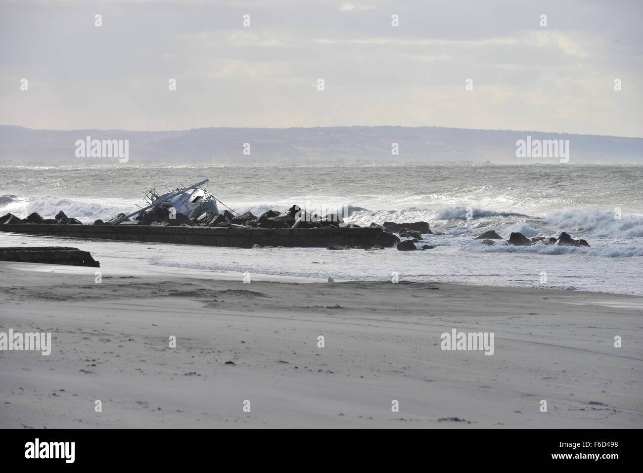 A Yacht being ship wrecked on the rocks on the beach at San Diego ...