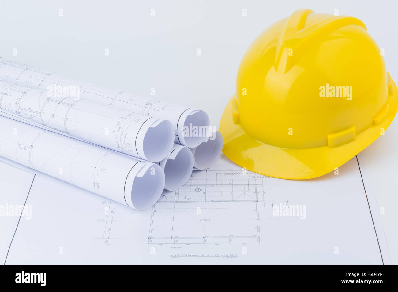 Yellow safety helmet and Scrolls of engineering drawings Stock Photo ...