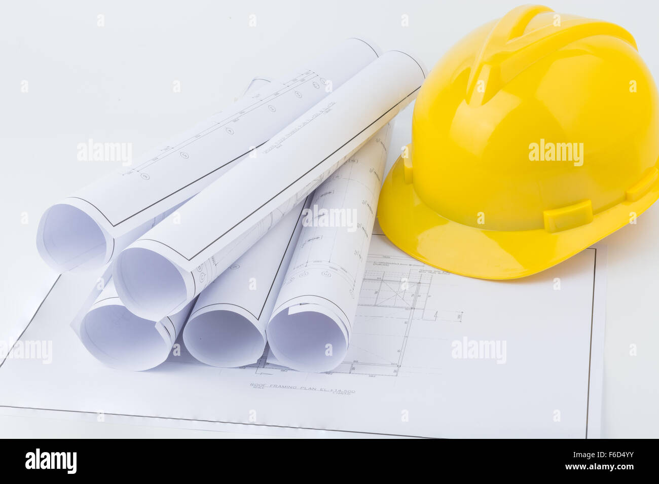 Yellow safety helmet and Scrolls of engineering drawings Stock Photo ...
