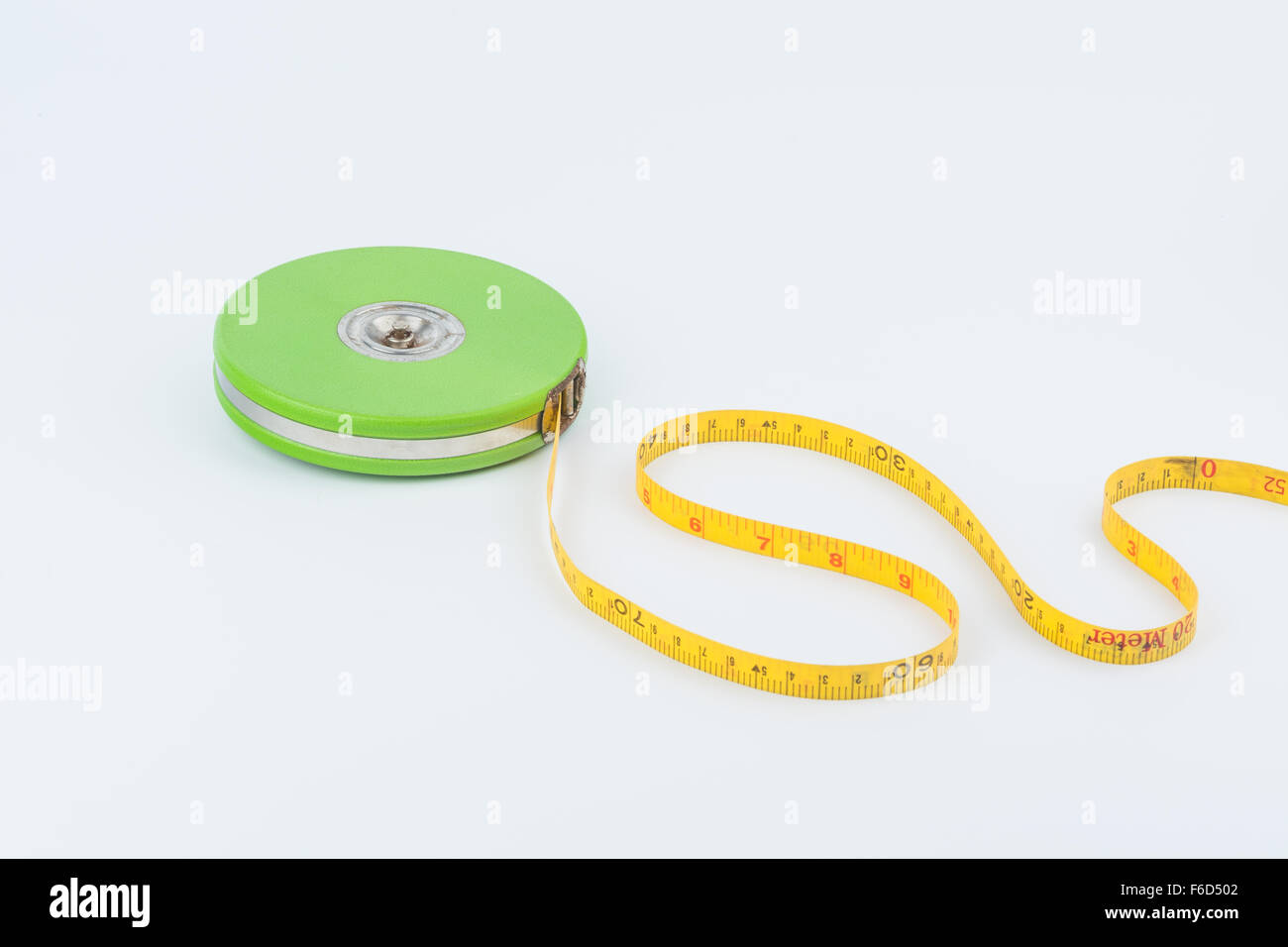 Green measuring tape for long distance measurement on white background ...