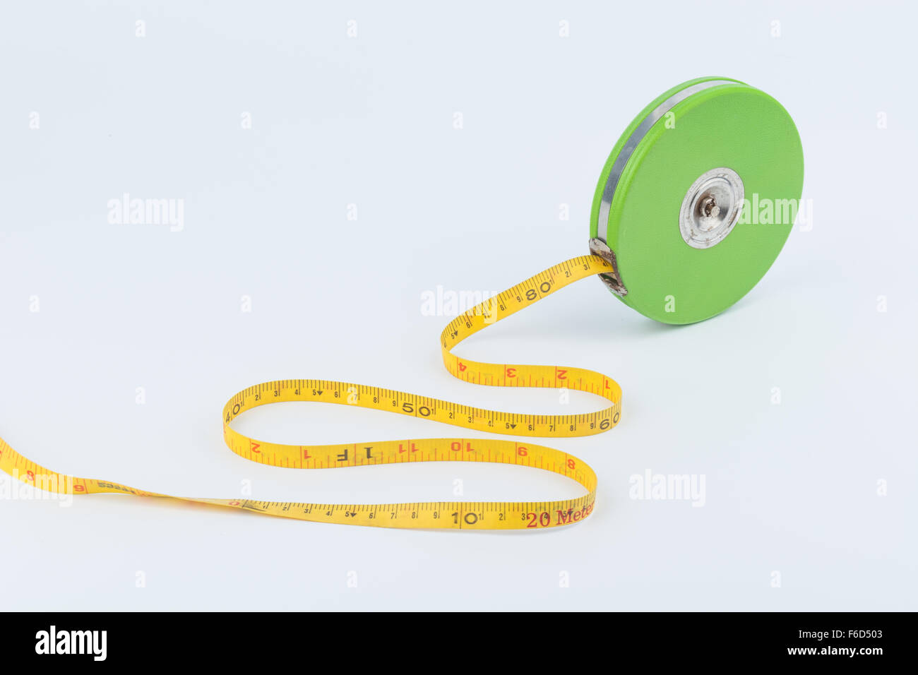 Green measuring tape for long distance measurement on white background ...