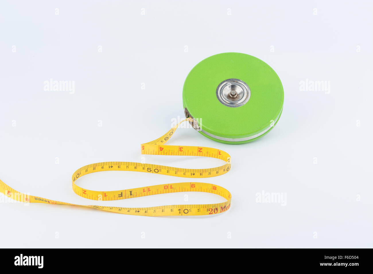 Green measuring tape for long distance measurement on white background ...