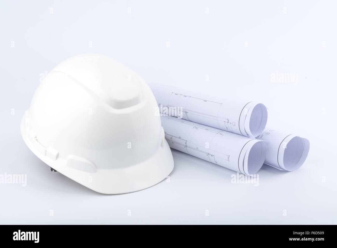 White safety helmet and Scrolls of engineering drawings Stock Photo - Alamy