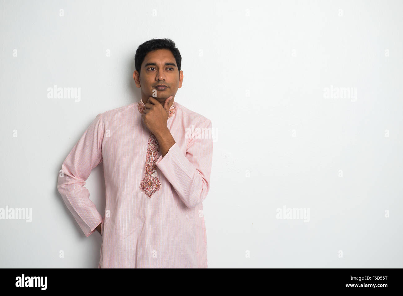 traditional indian male thinking with plain background and copyspace on ...