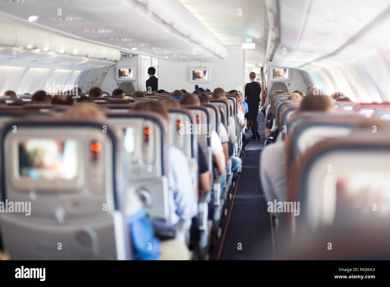 Interior of airplane with passengers on seats Stock Photo - Alamy