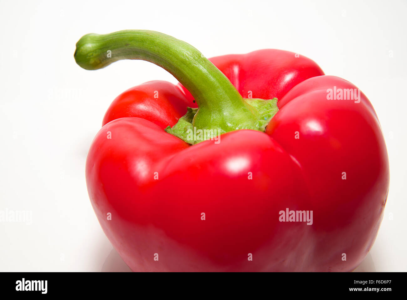 One red pepper on a white background Stock Photo - Alamy
