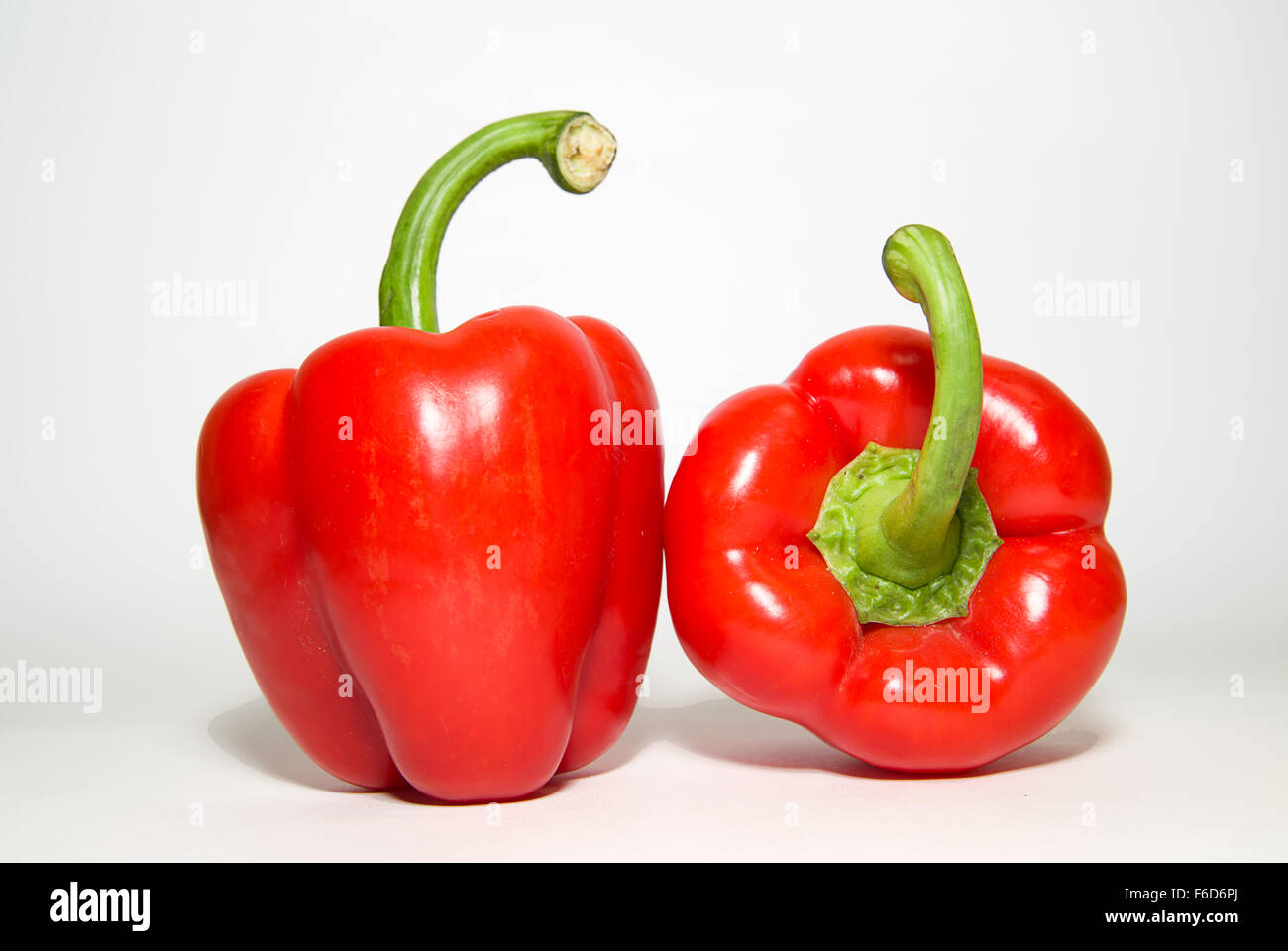 Two red peppers on a white background Stock Photo - Alamy