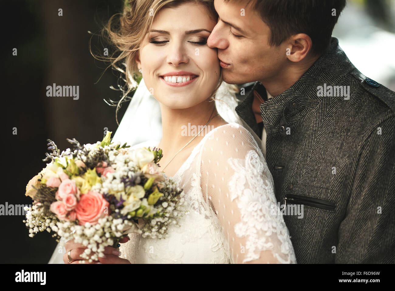 Groom hugs bride Stock Photo - Alamy