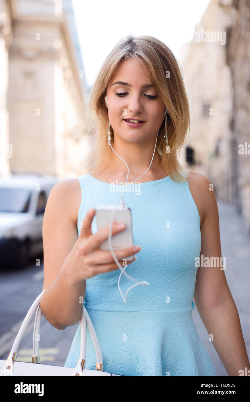 young woman in the street using her phone Stock Photo - Alamy