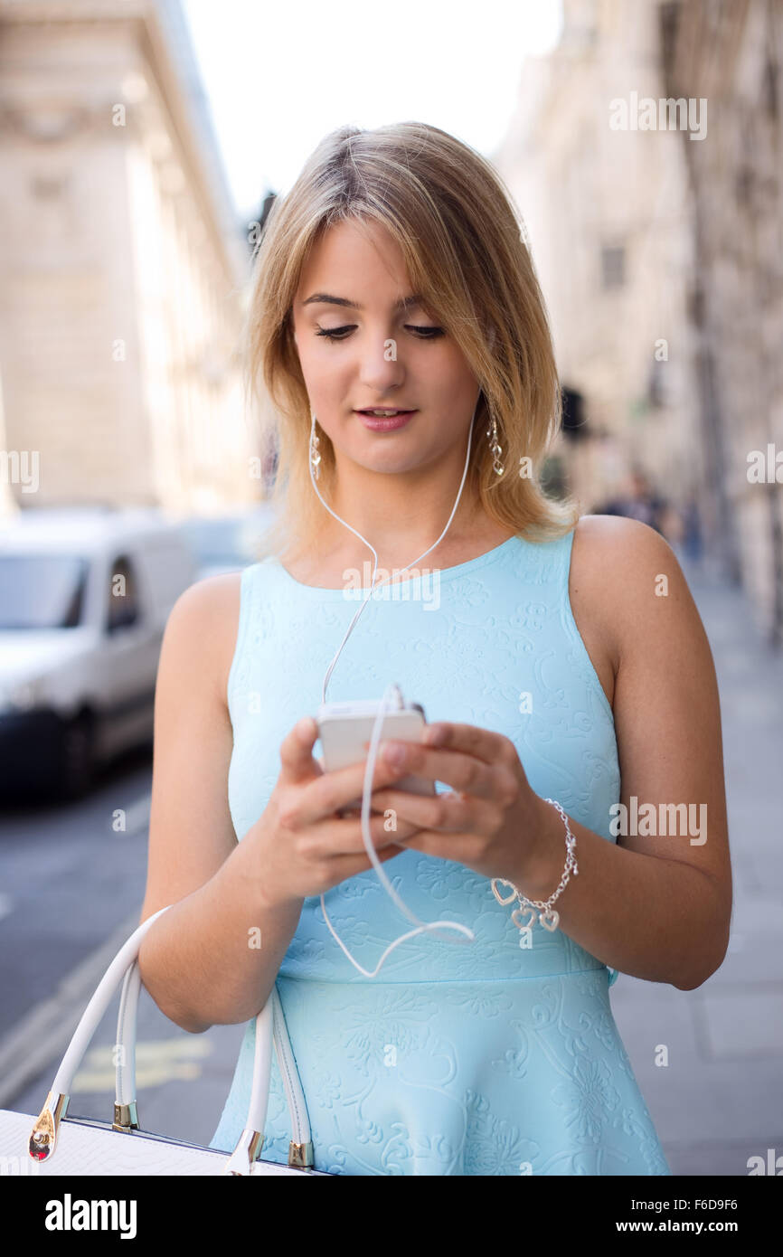 Person using mobile device on street hi-res stock photography and ...