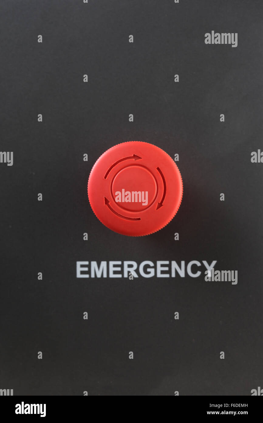 Front view of red plastic emergency stop button on on metallic color ...