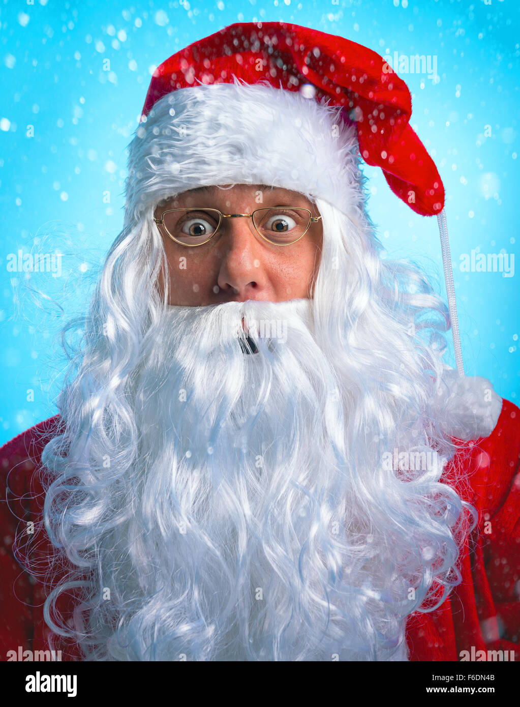 Portrait of surprised a Santa Claus on a blue background Stock Photo ...