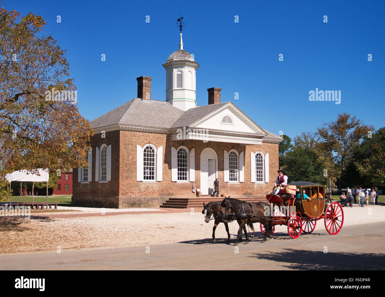 Horse drawn carriage passing the courthouse, Colonial Williamsburg ...