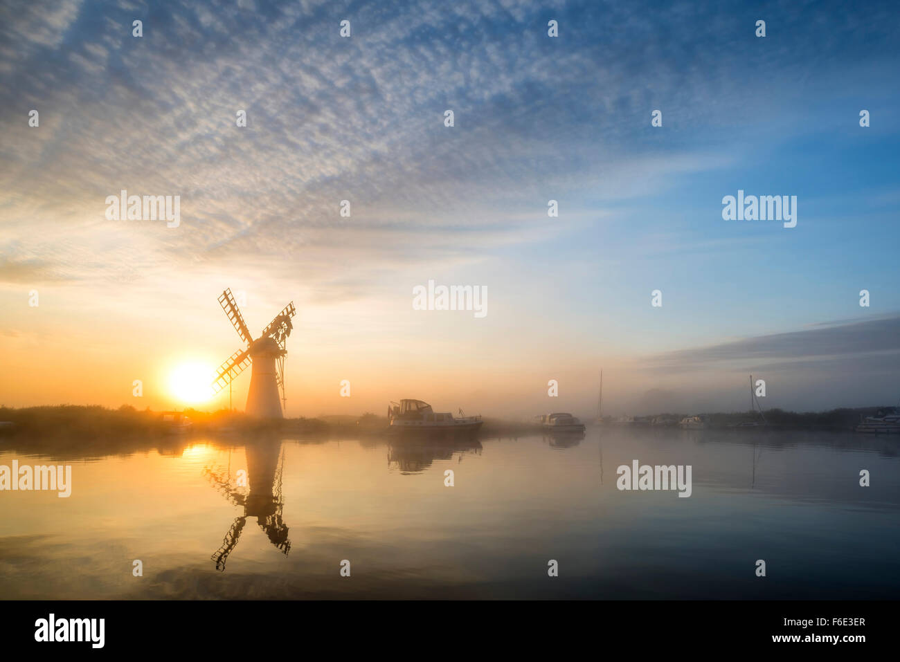 Stunnnig landscape of windmill and river at sunrise on Summer morning ...