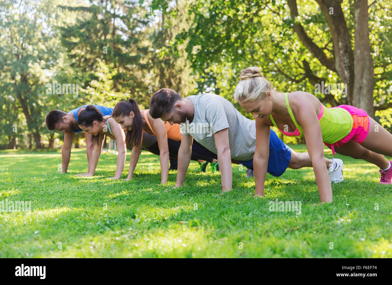 group of friends or sportsmen exercising outdoors Stock Photo - Alamy