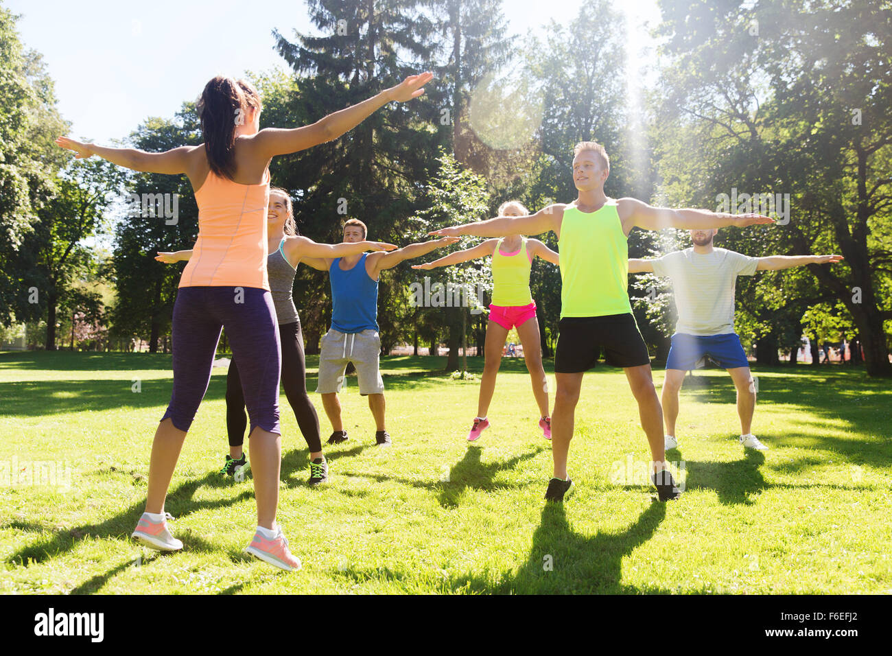 group of happy friends exercising outdoors Stock Photo - Alamy