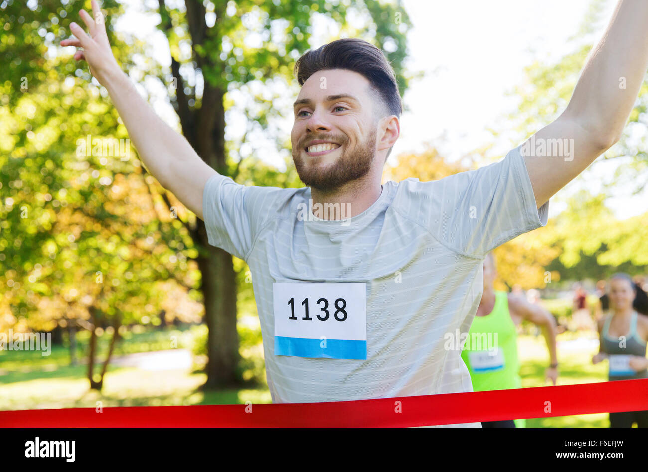 happy young male runner winning on race finish Stock Photo - Alamy