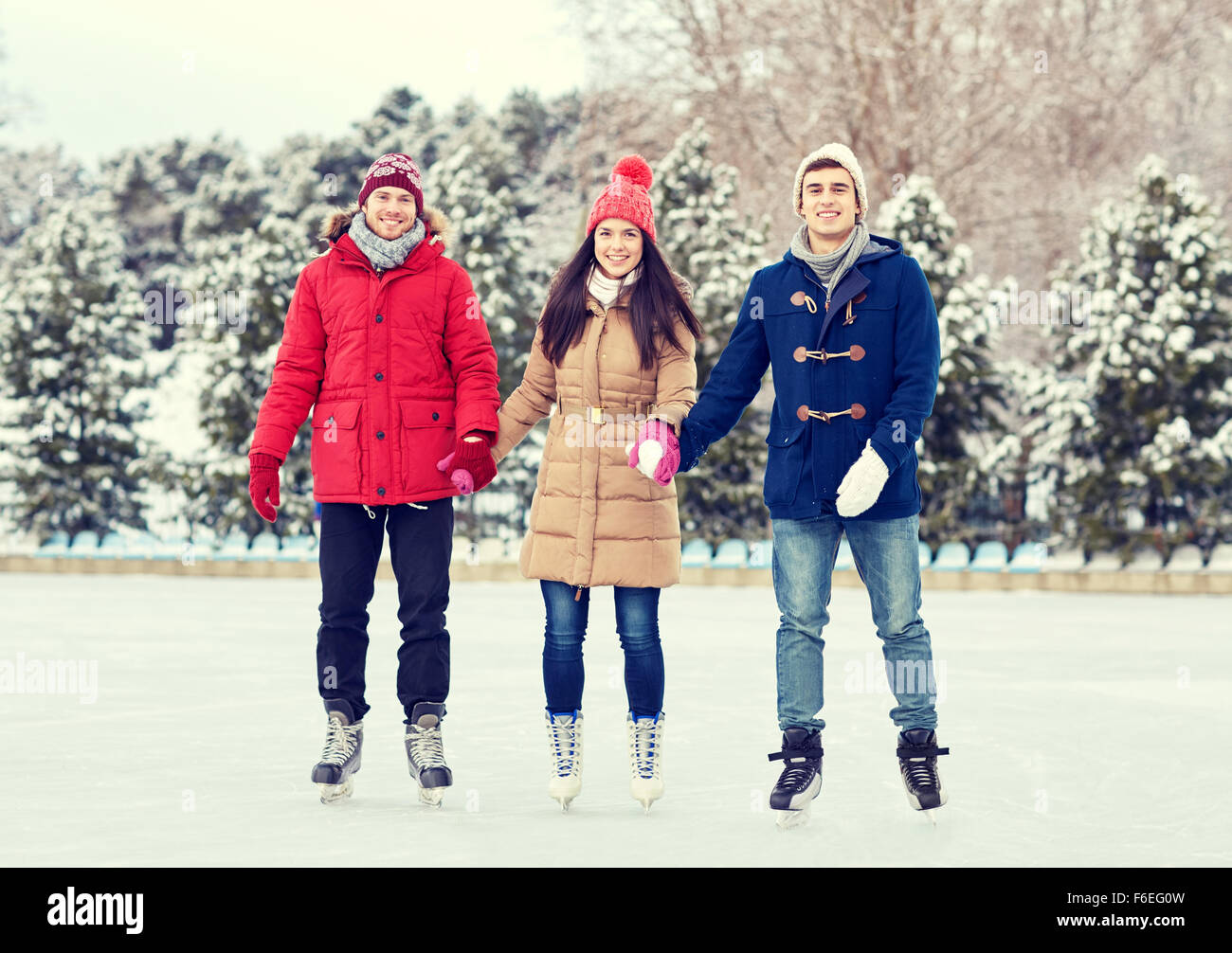 happy friends ice skating on rink outdoors Stock Photo - Alamy