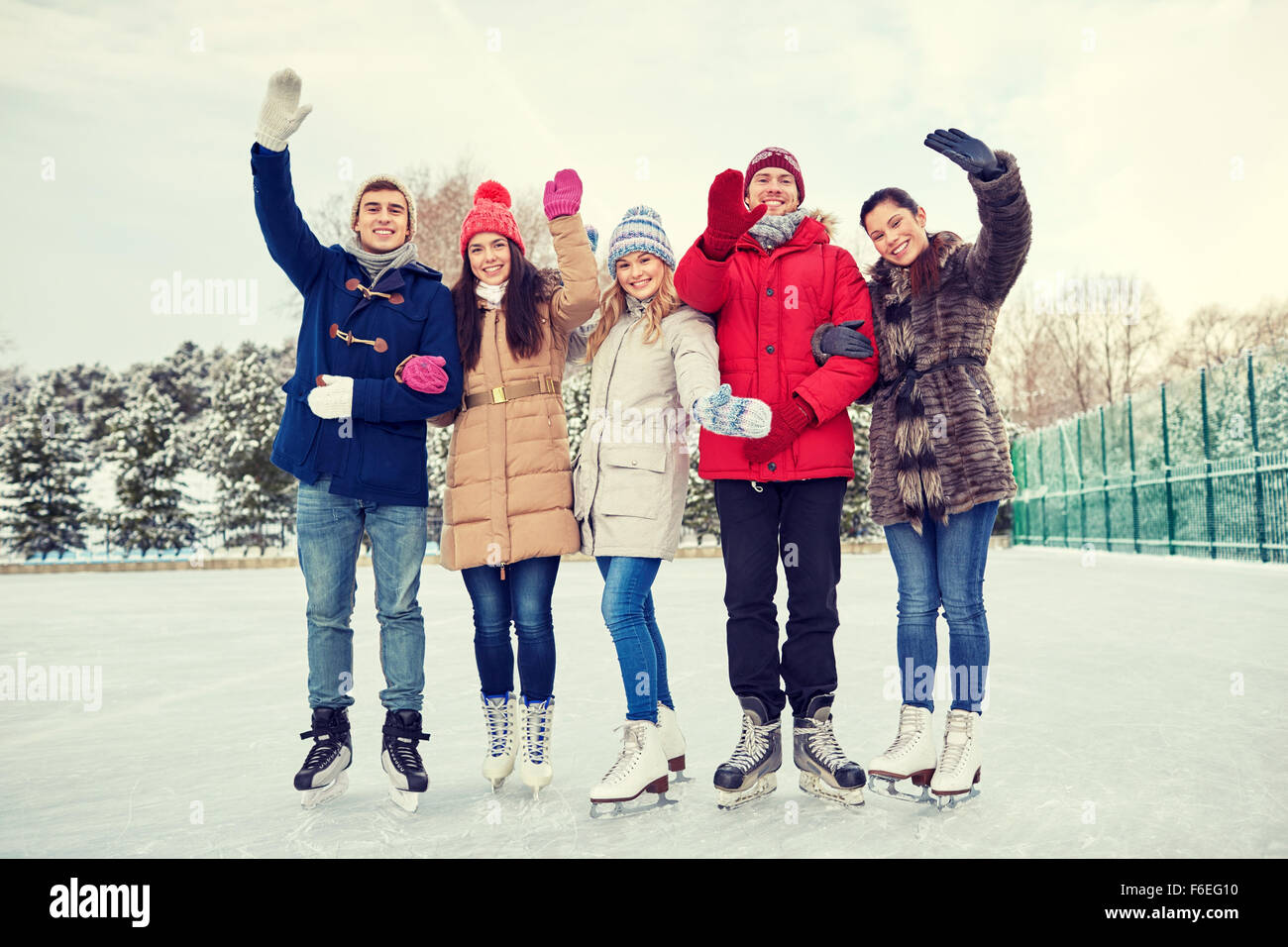 happy friends ice skating on rink outdoors Stock Photo - Alamy