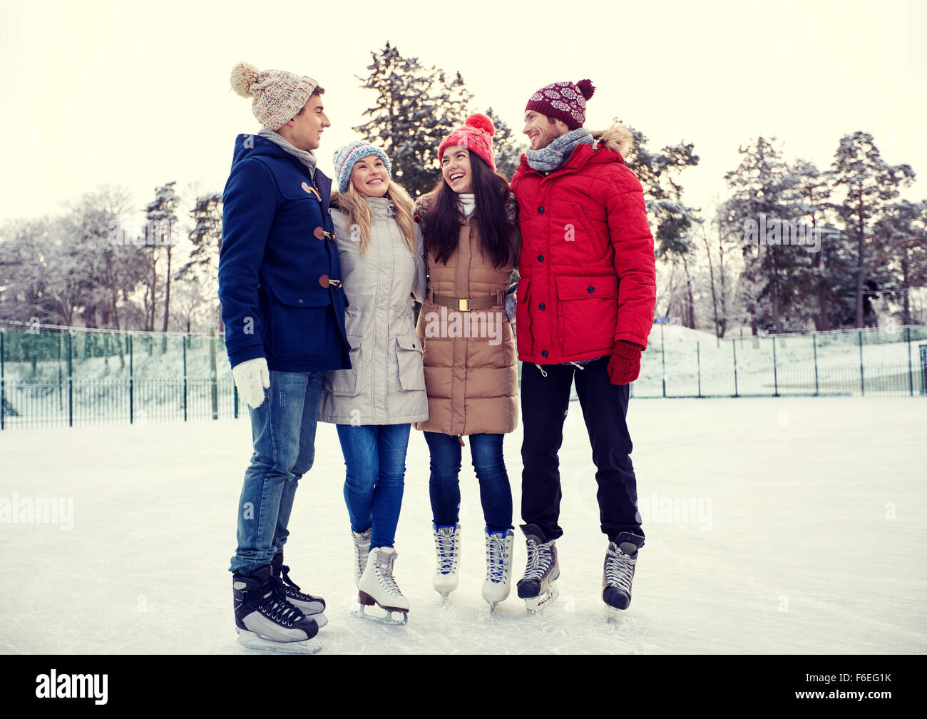 happy friends ice skating on rink outdoors Stock Photo - Alamy
