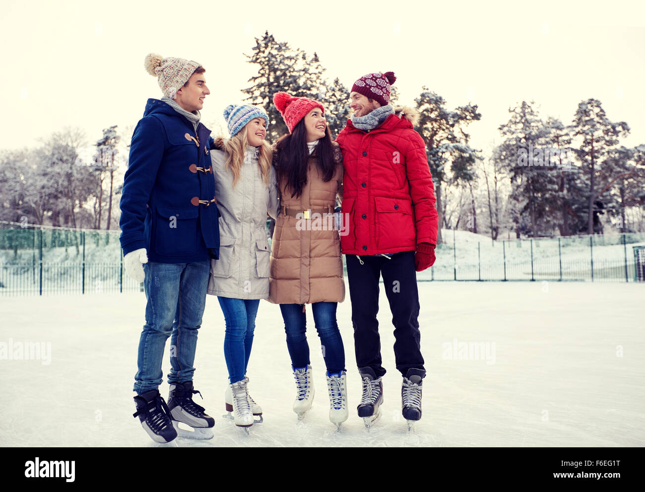 happy friends ice skating on rink outdoors Stock Photo - Alamy