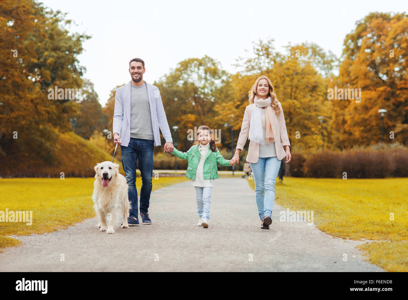 happy family with labrador retriever dog in park Stock Photo - Alamy