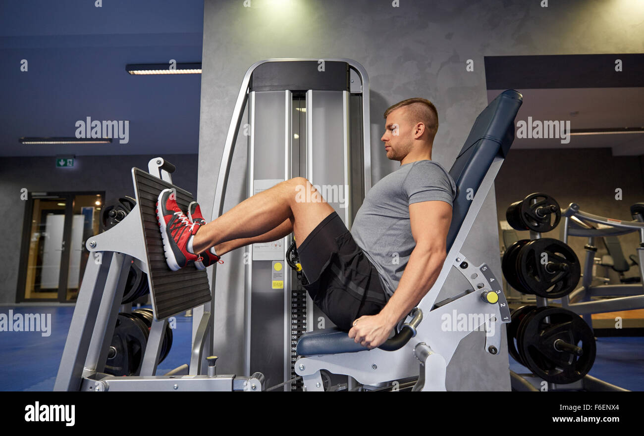 man flexing leg muscles on gym machine Stock Photo - Alamy