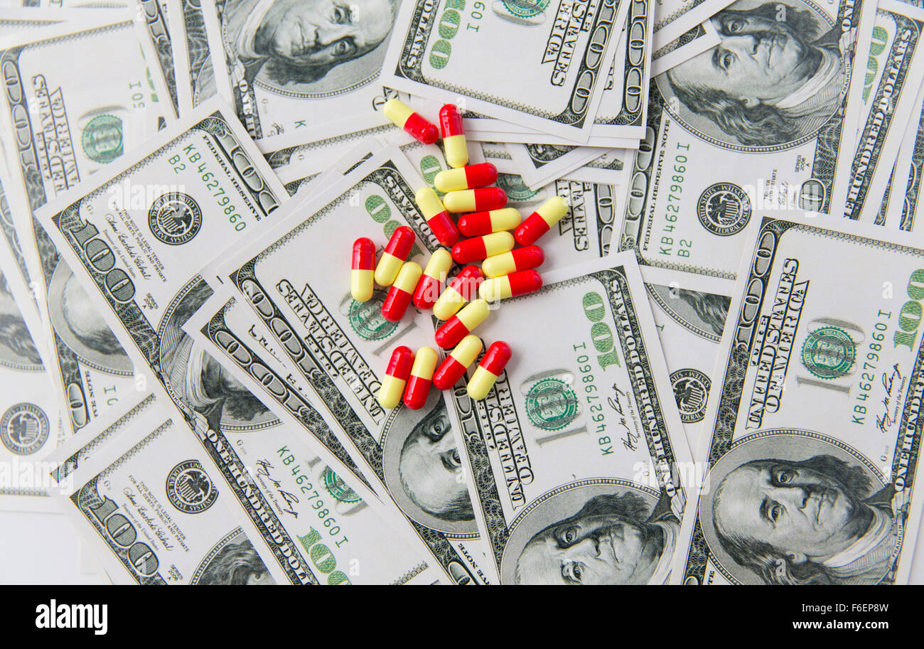 medical pills or drugs and dollar cash money Stock Photo - Alamy