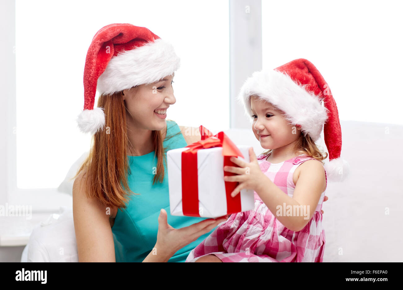 happy mother and child in santa hats with gift box Stock Photo - Alamy