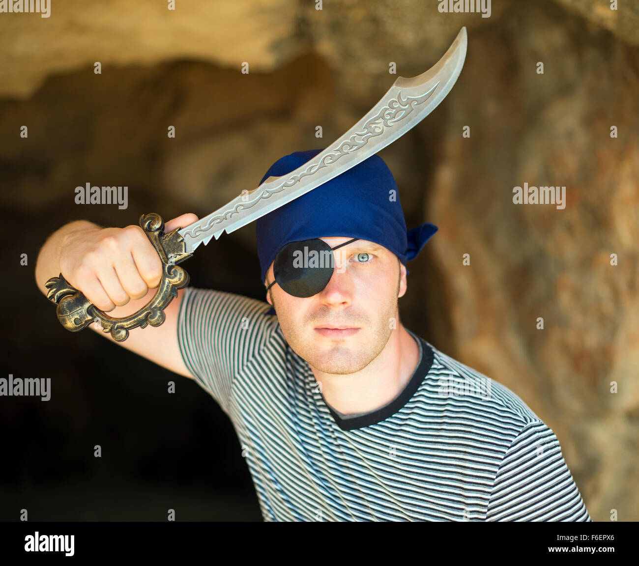 Male pirate with sword near the cave entrance Stock Photo - Alamy