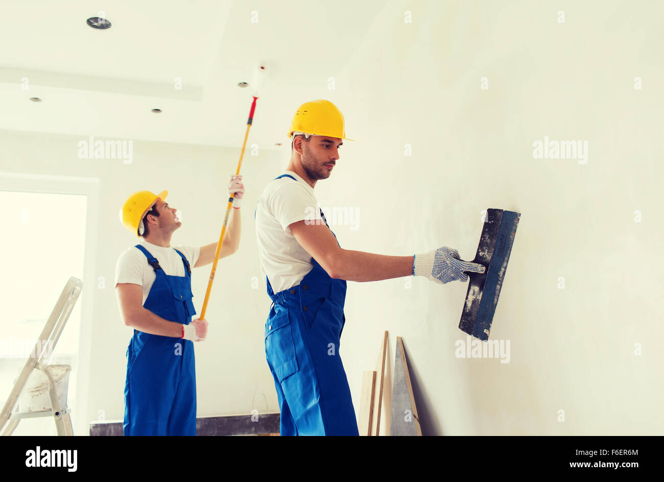 group of builders with tools indoors Stock Photo - Alamy