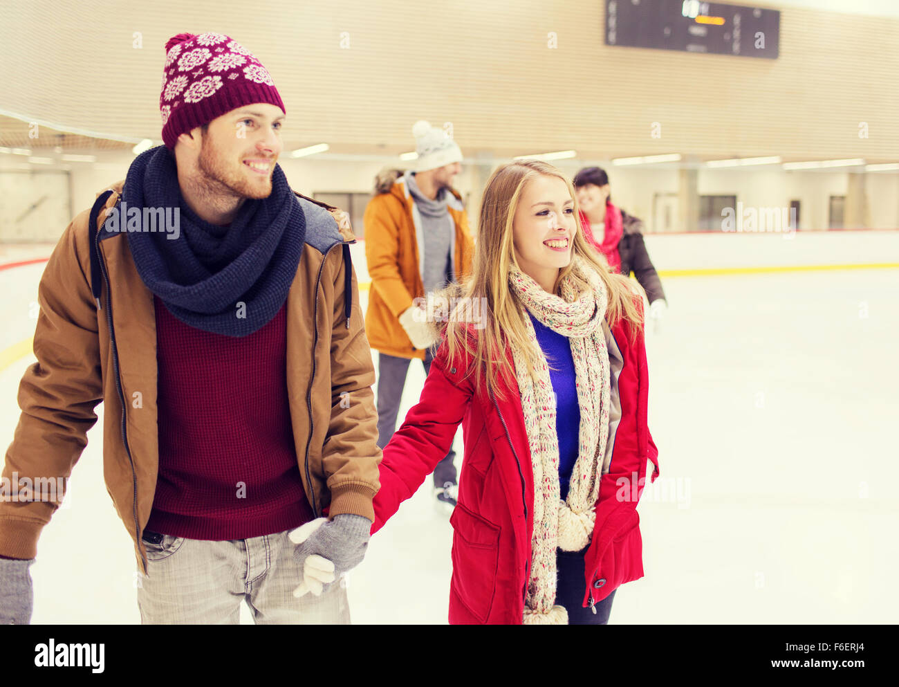 happy friends on skating rink Stock Photo - Alamy