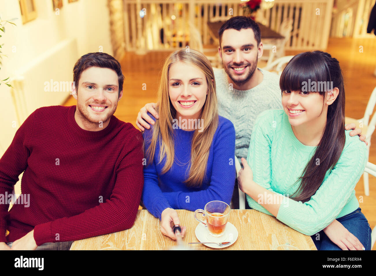 group of friends taking picture with selfie stick Stock Photo - Alamy