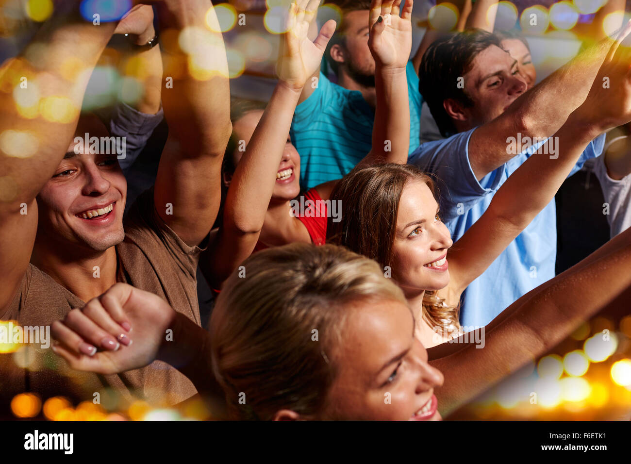 group of smiling friends at concert in club Stock Photo - Alamy