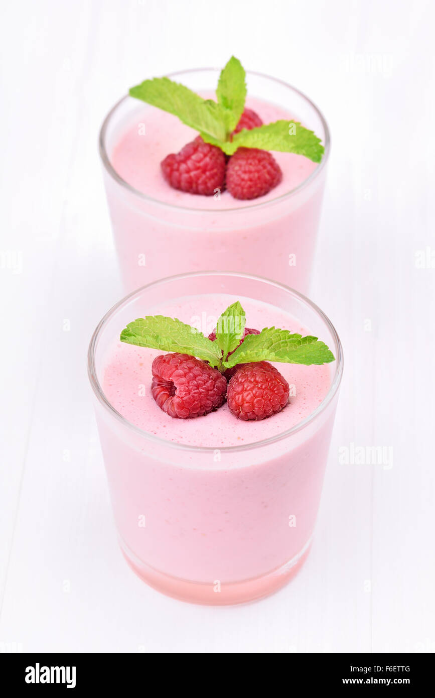 Raspberry smoothie in glass on white background Stock Photo - Alamy