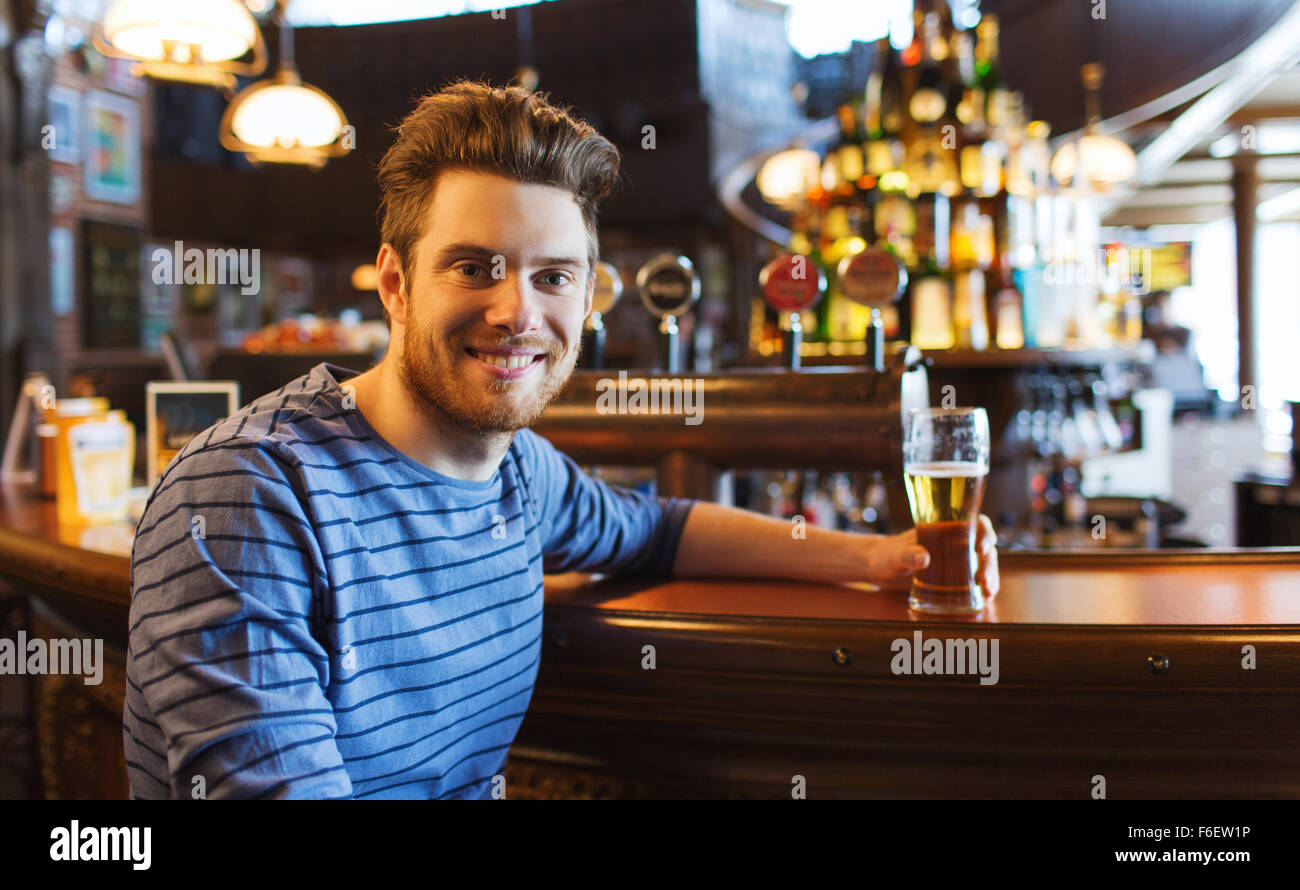 happy man drinking beer at bar or pub Stock Photo - Alamy