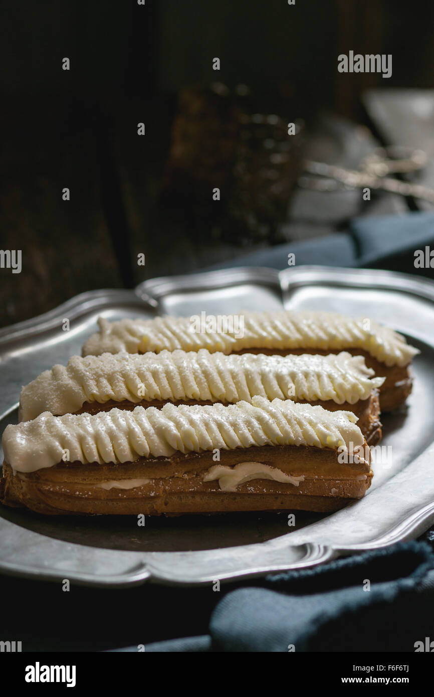 Eclairs in metal plate Stock Photo - Alamy