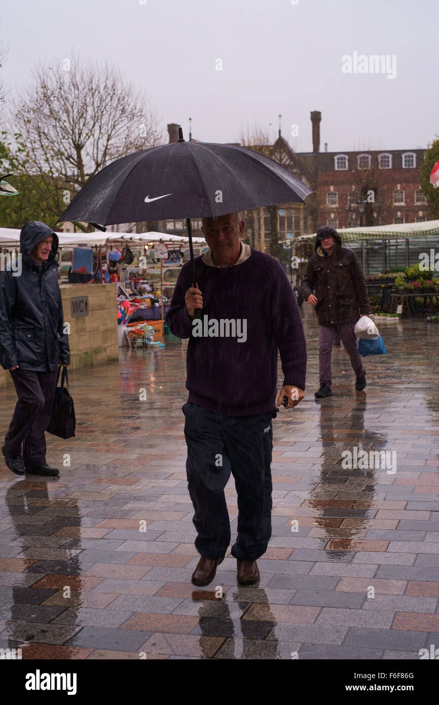 A tourist shopping at the market on a very wet day shopping in ...