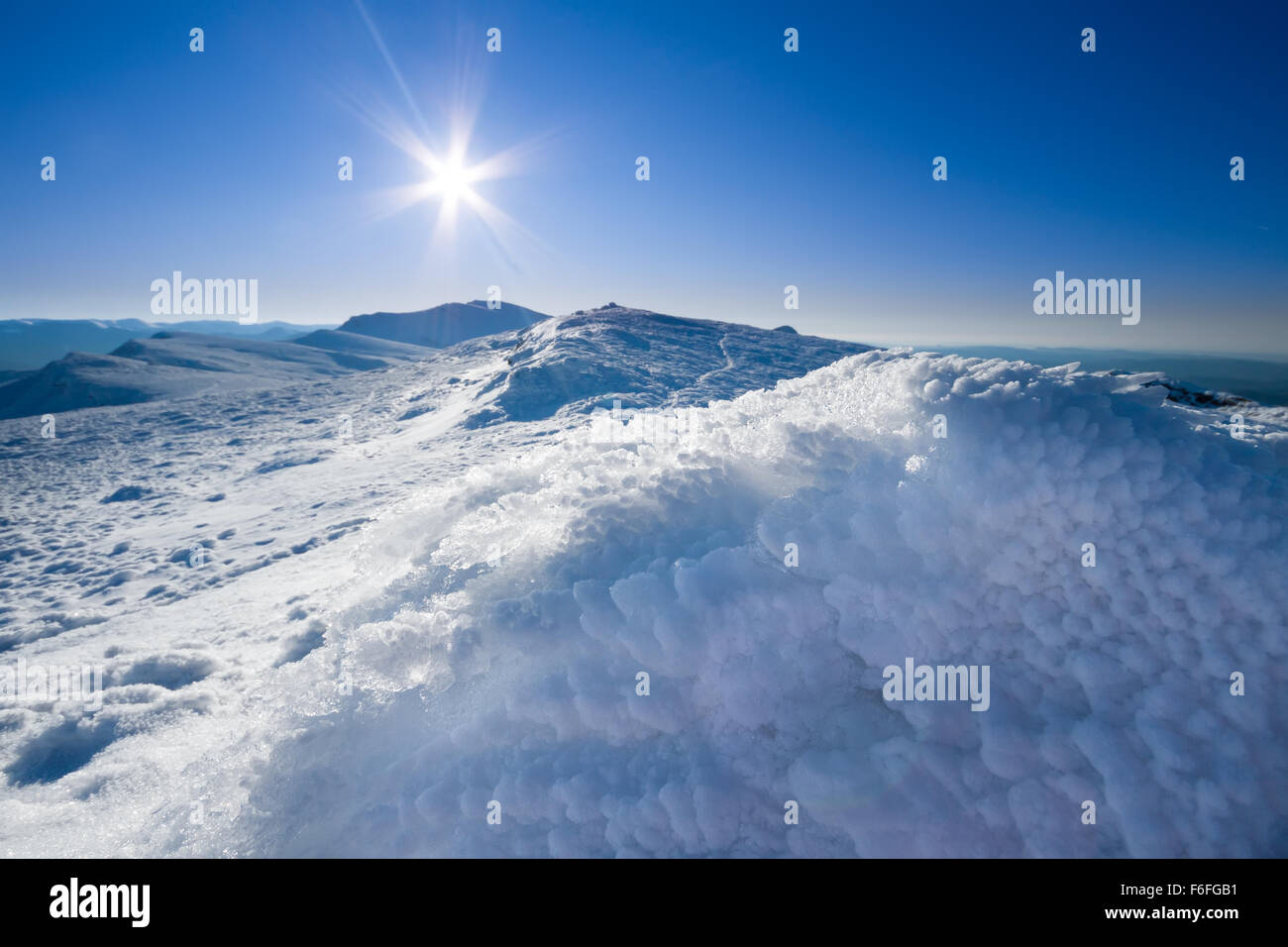 Sun and snow mountains landscape Stock Photo - Alamy