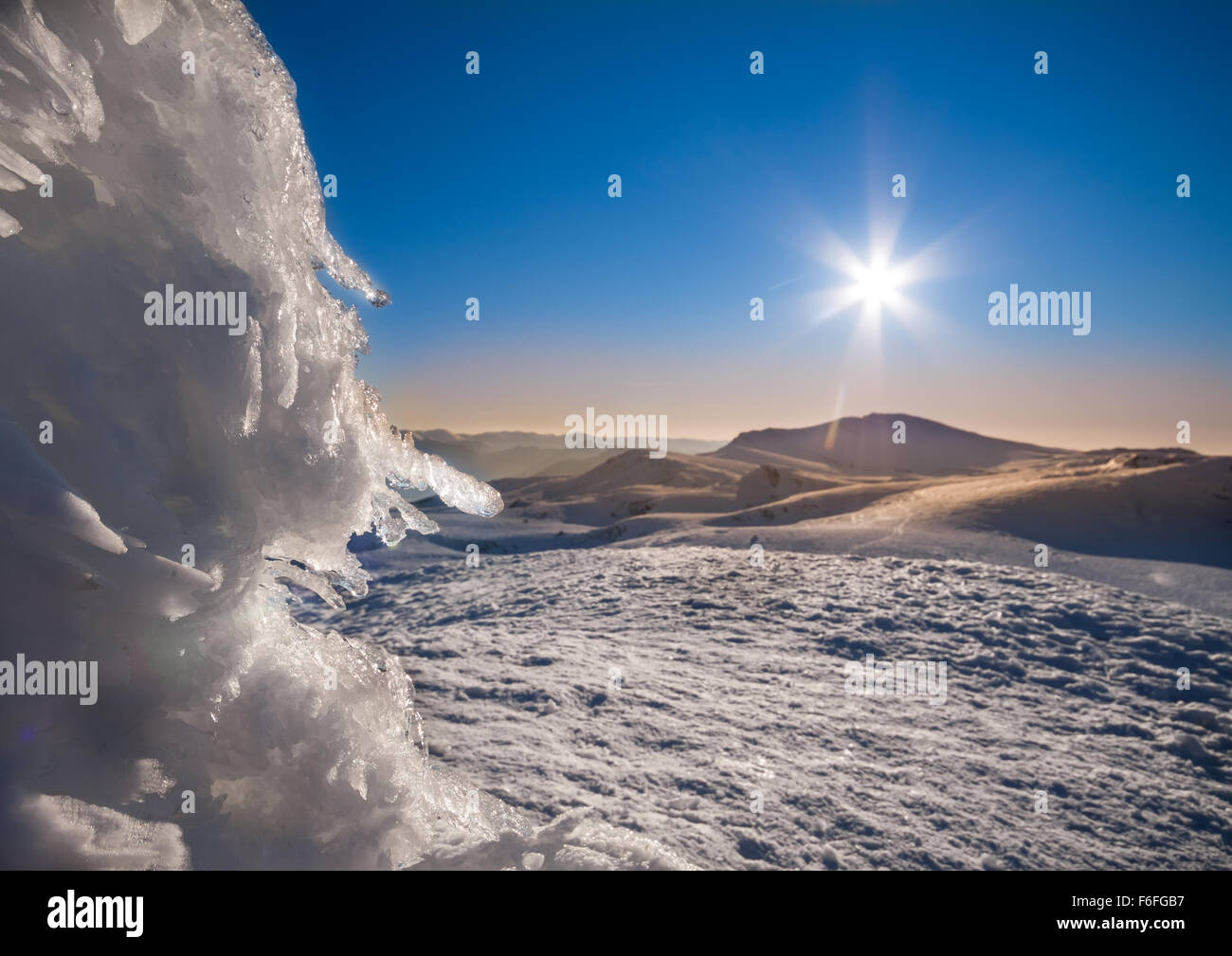 Sun and snow mountains landscape Stock Photo - Alamy