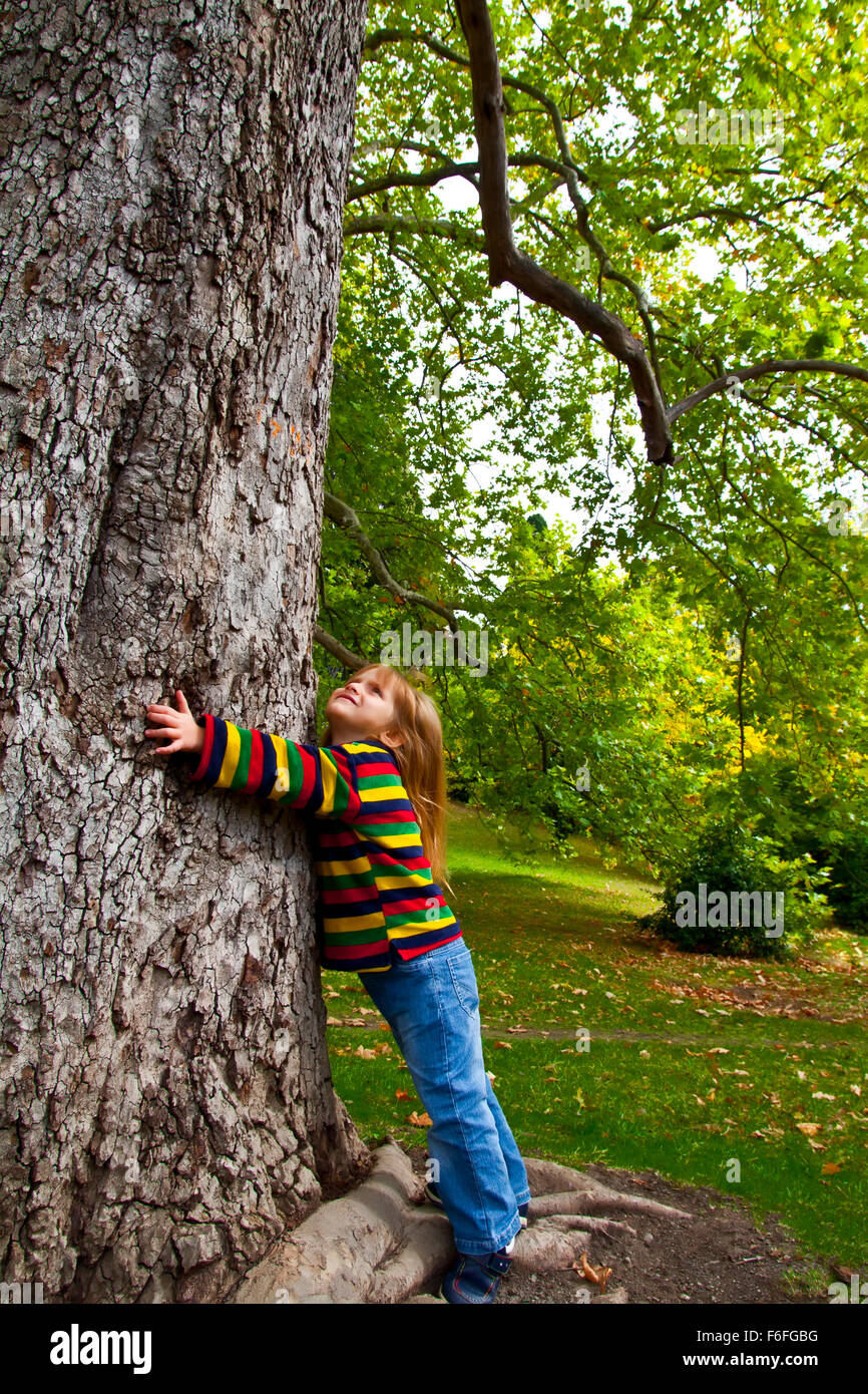 Tree hugging child grow hi-res stock photography and images - Alamy