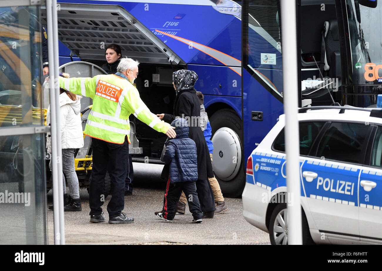 A group of women and children step out of a bus on their way to board ...