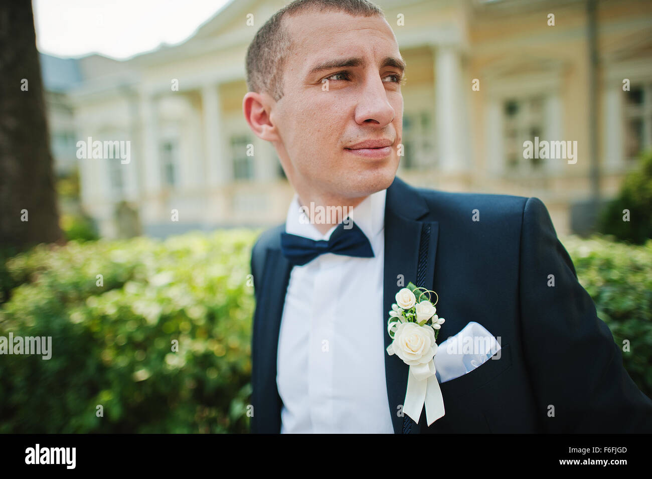 seriously groom at bow tie Stock Photo - Alamy