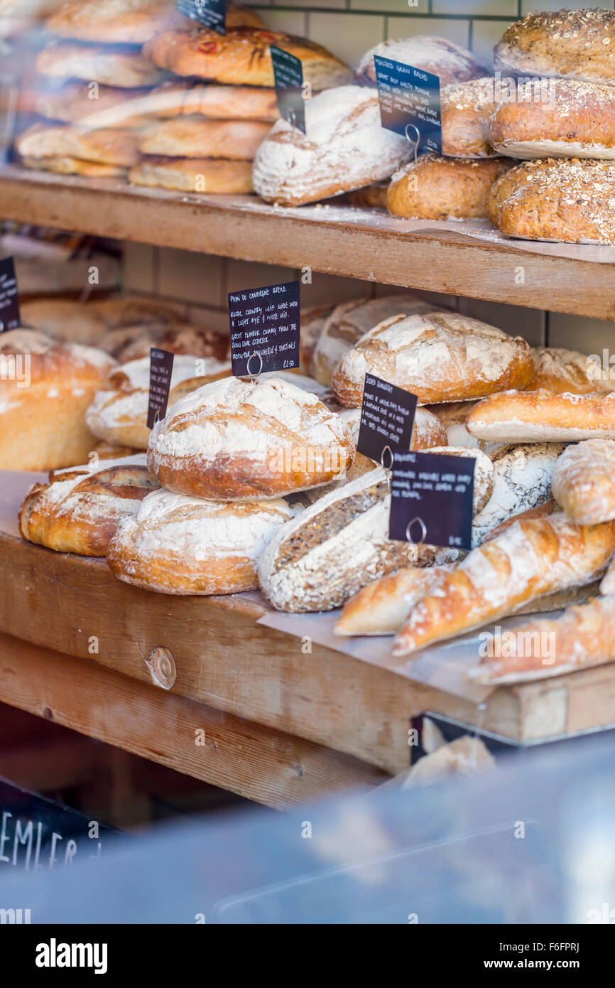 Fresh bread on display in a bakers shop window Stock Photo - Alamy