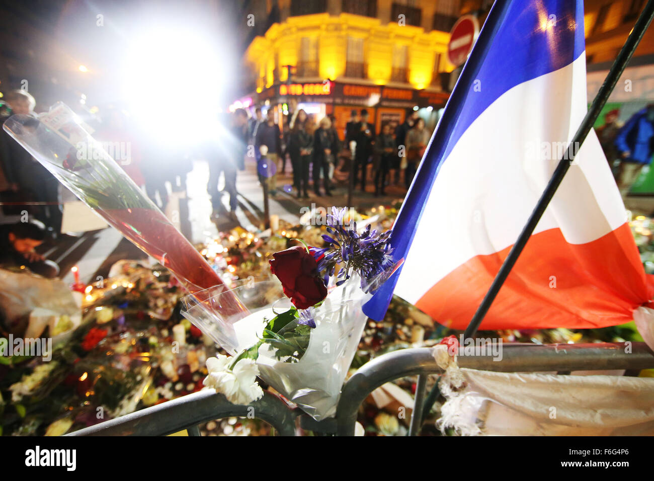 Mourners light candles and lay flowers in front of the Bataclan Theater ...