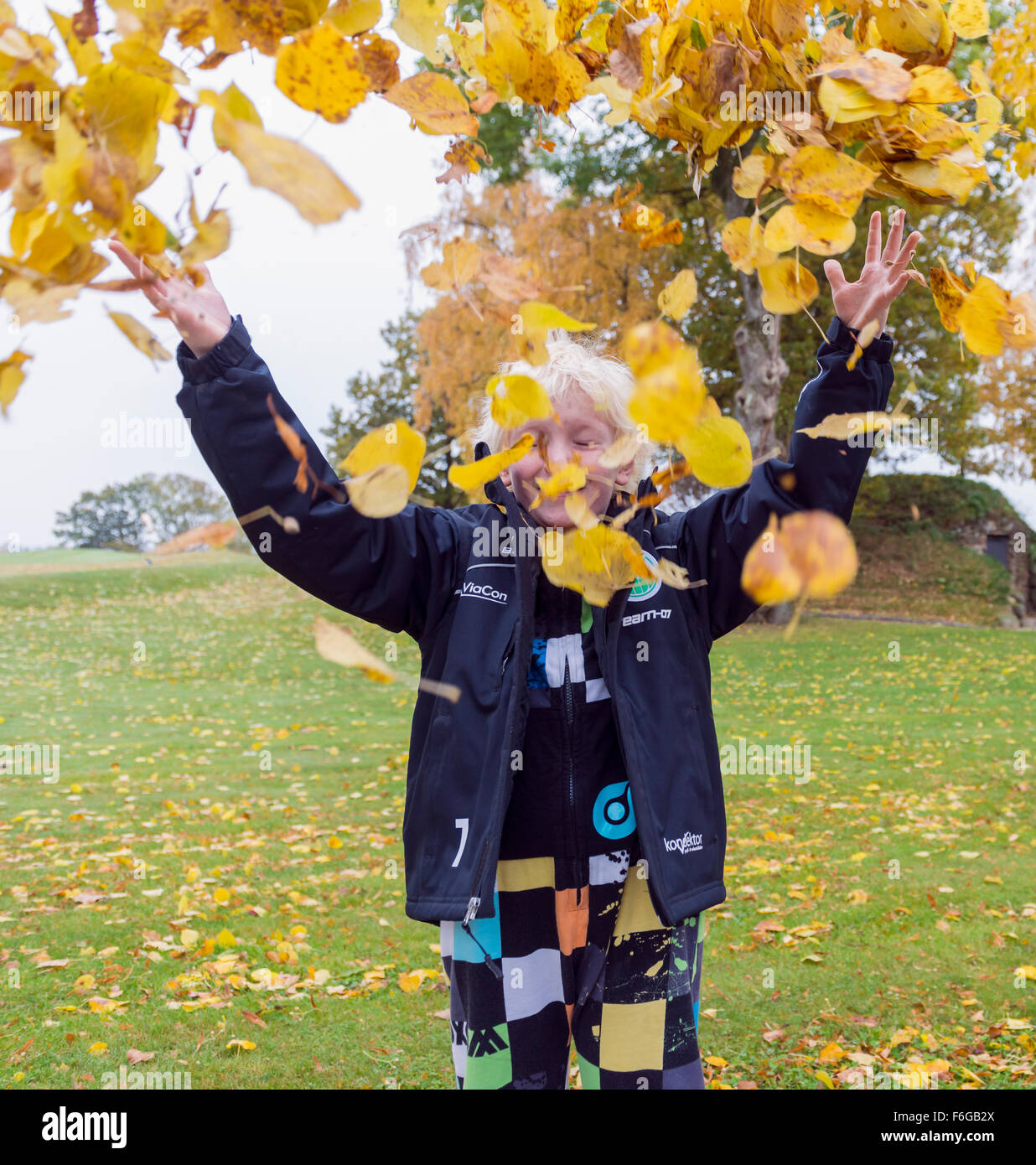 Children throwing autumn leaves hi-res stock photography and images - Alamy