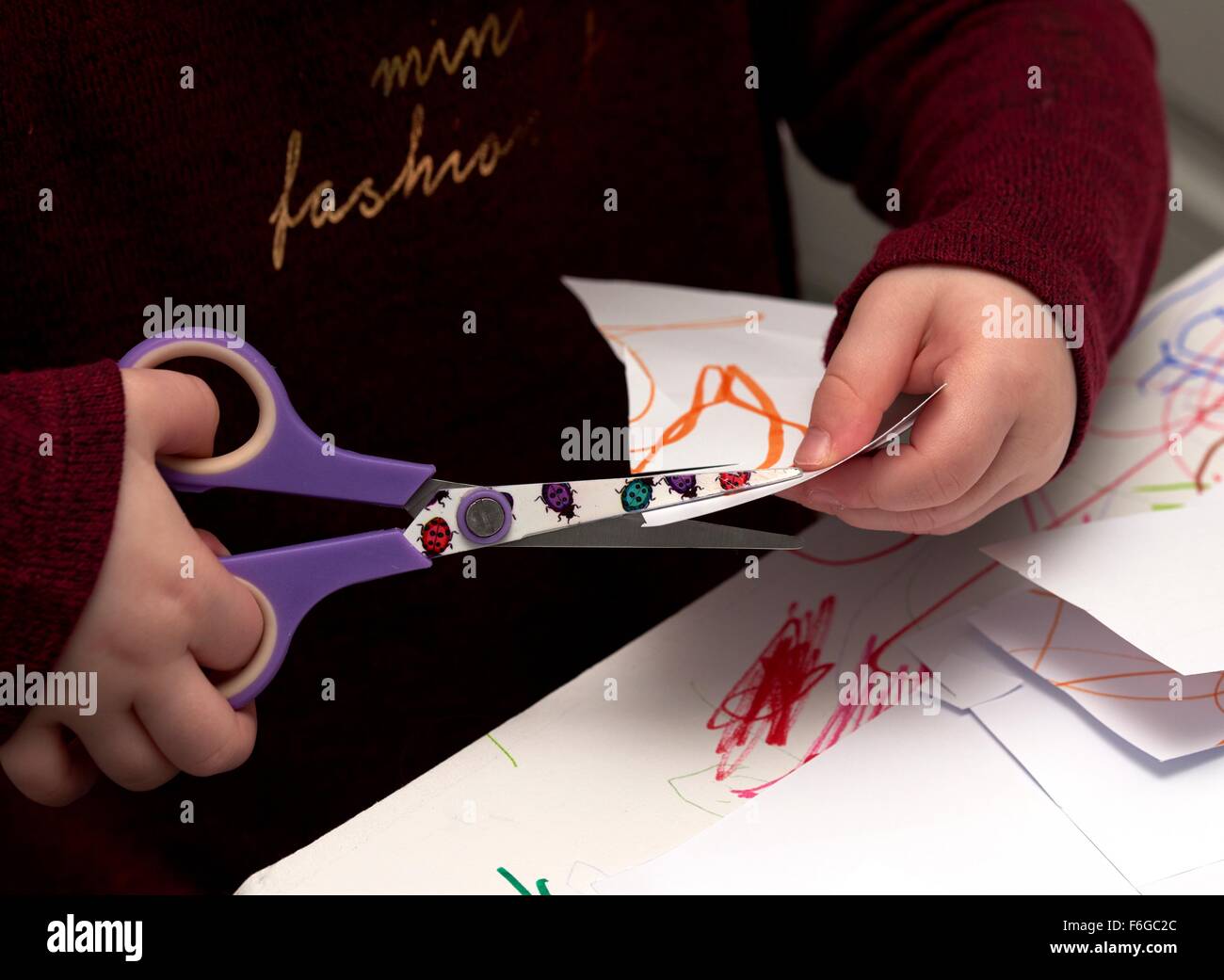 A 3 year old girl learning to use scissors Stock Photo - Alamy